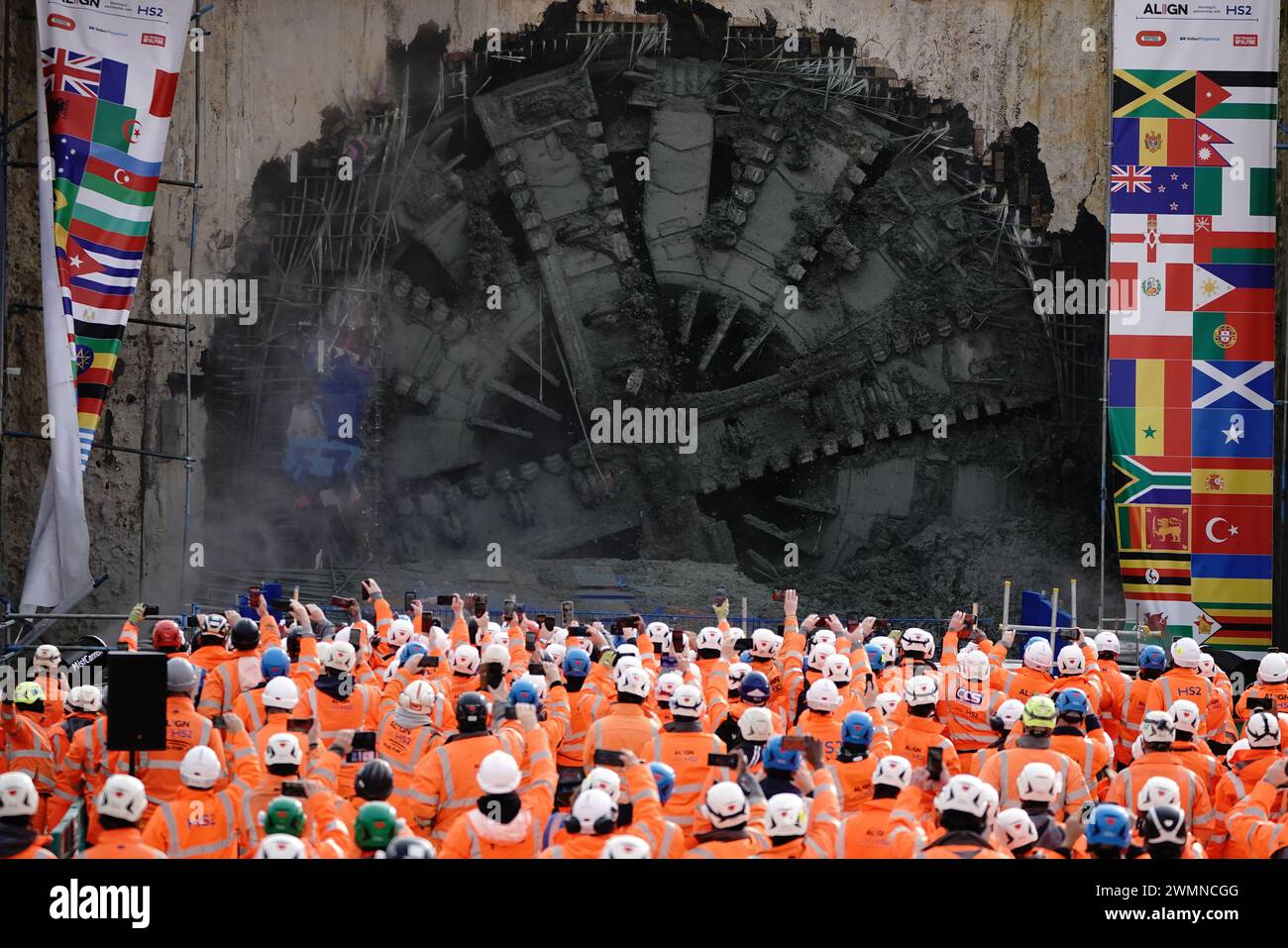 Workers hold up their mobile phones as digging machine Florence ...