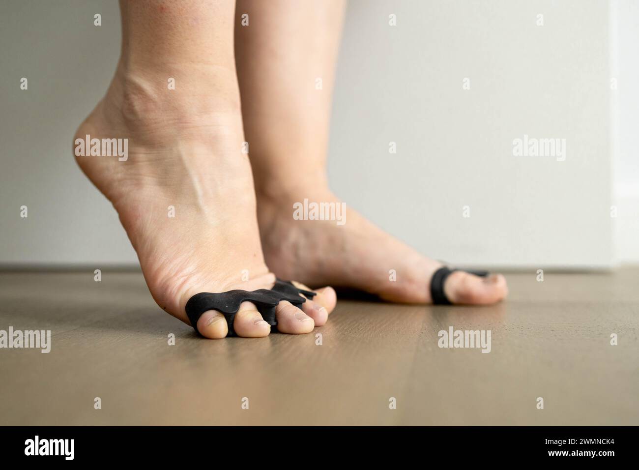 Healthy feet wearing toes spacers Stock Photo - Alamy