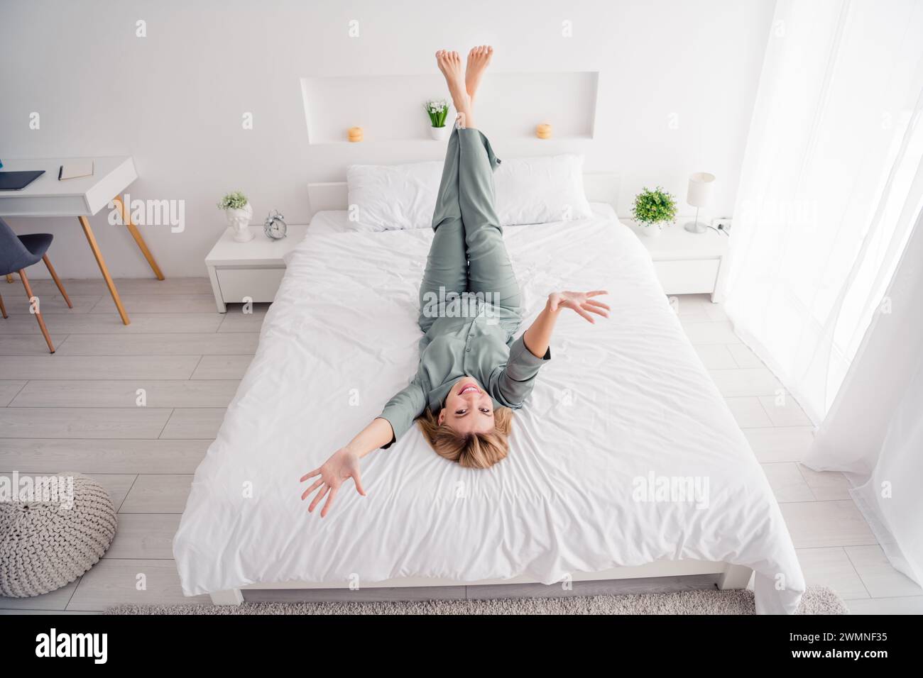 Full body length photo of relaxed blonde girl have rest in bedroom ...