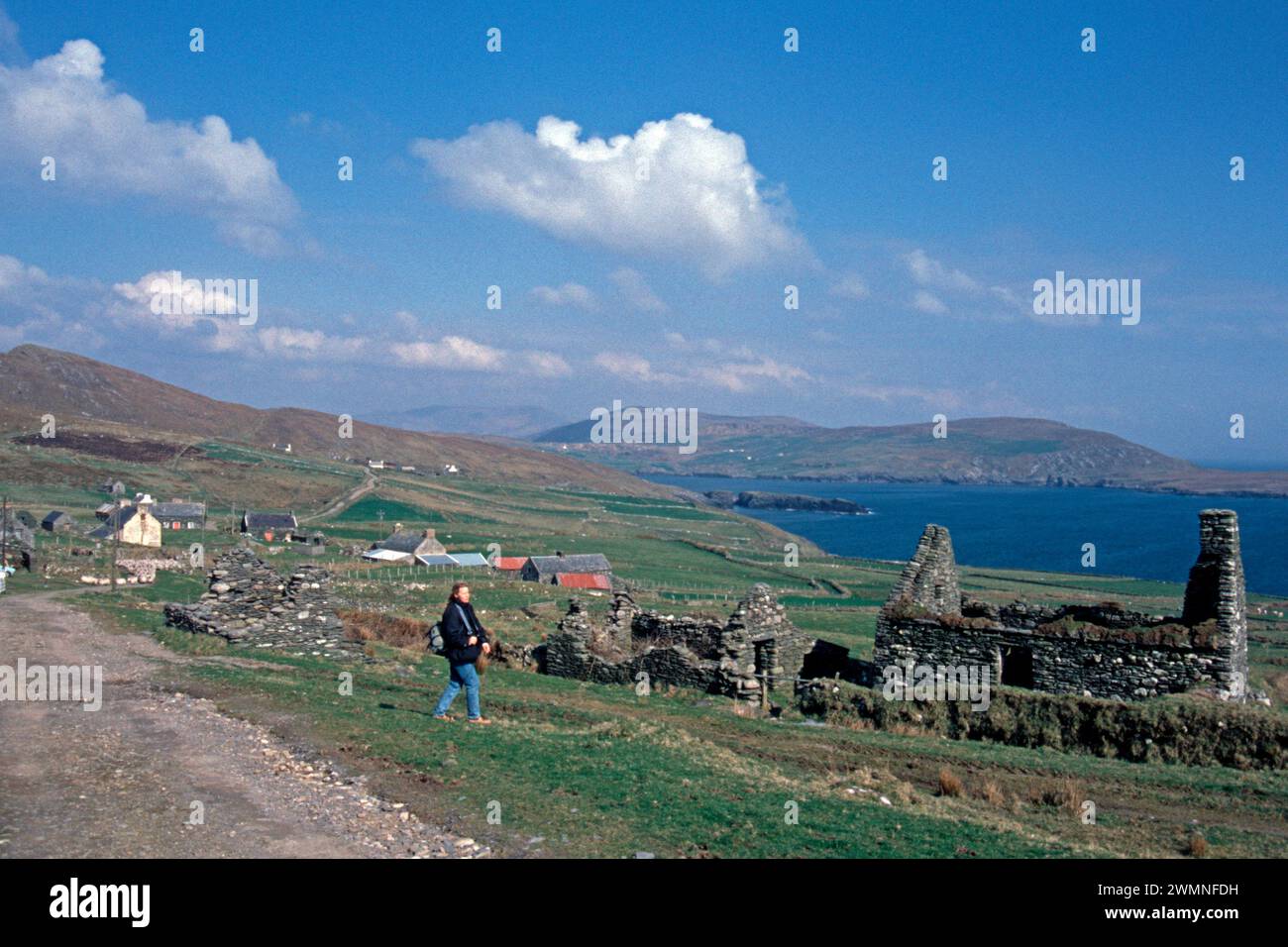 Houses, stone walls, view of the mainland, woman, Dursey Island, Beara ...