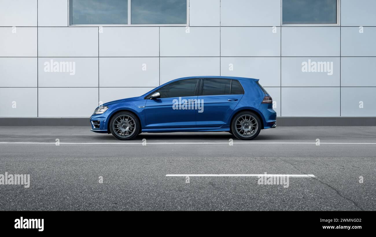 Lapiz blue mk7 Volkswagen Golf R near grey wall. Side profile view of ...