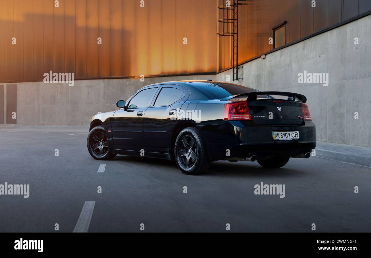 black Dodge Charger RT sedan in urban setting. Three quarter rear view ...