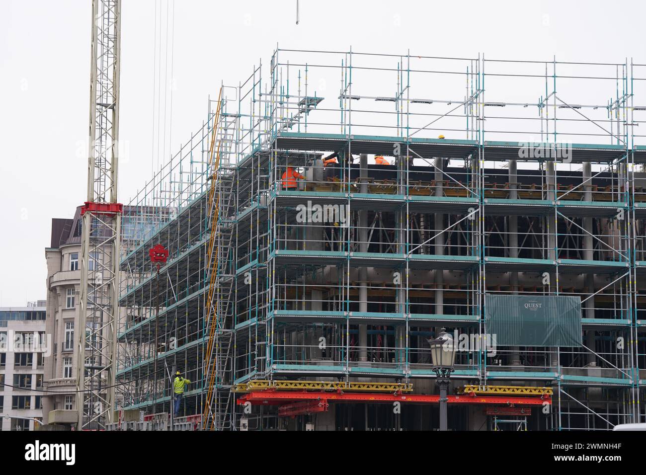 Construction workers stand on scaffolding hi-res stock photography and ...