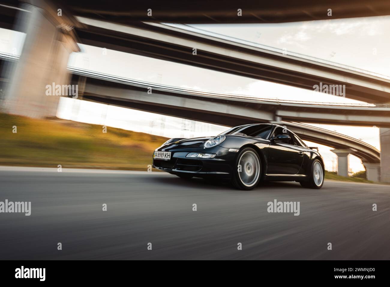 motion shot of black Porsche 911 Carrera coupe. Porsche 997 driving ...