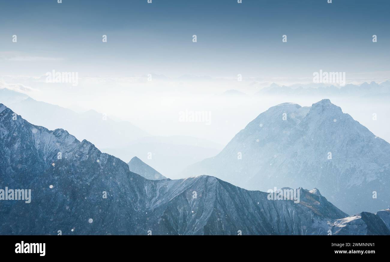 Cold blue mountains on a sunny day - backlit image with silhouettes of ...