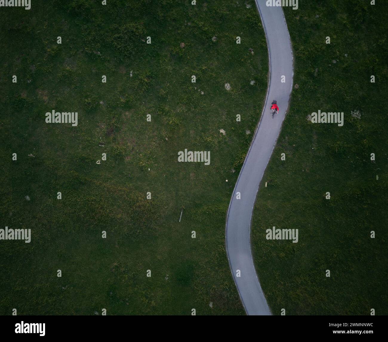 Aerial view of a man biking on a wavy path Stock Photo - Alamy