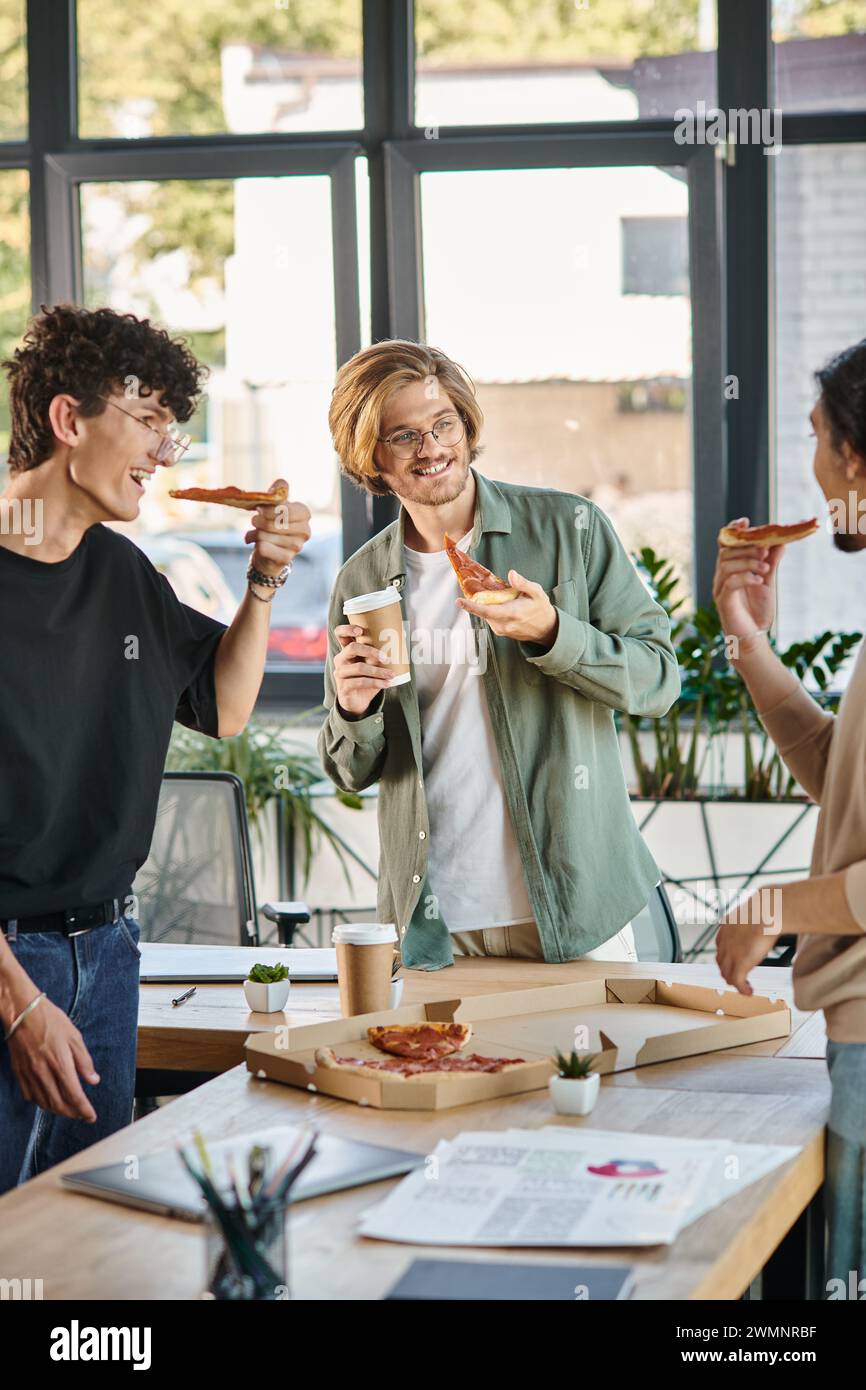 happy men enjoying a pizza lunch break in a friendly and relaxed office ...