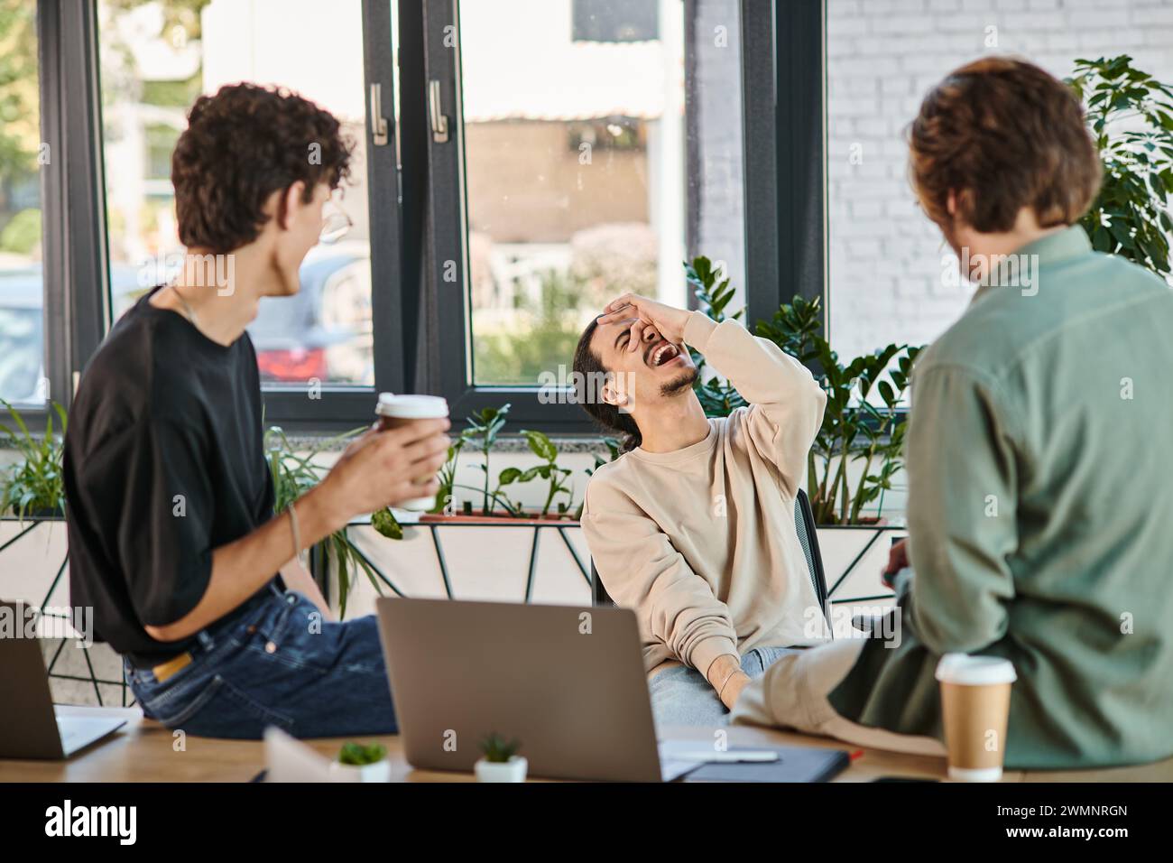 cheerful team member expressing genuine emotion during a coffee break ...