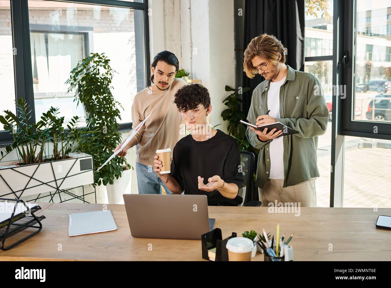 young entrepreneurs brainstorming over a laptop in a modern office ...