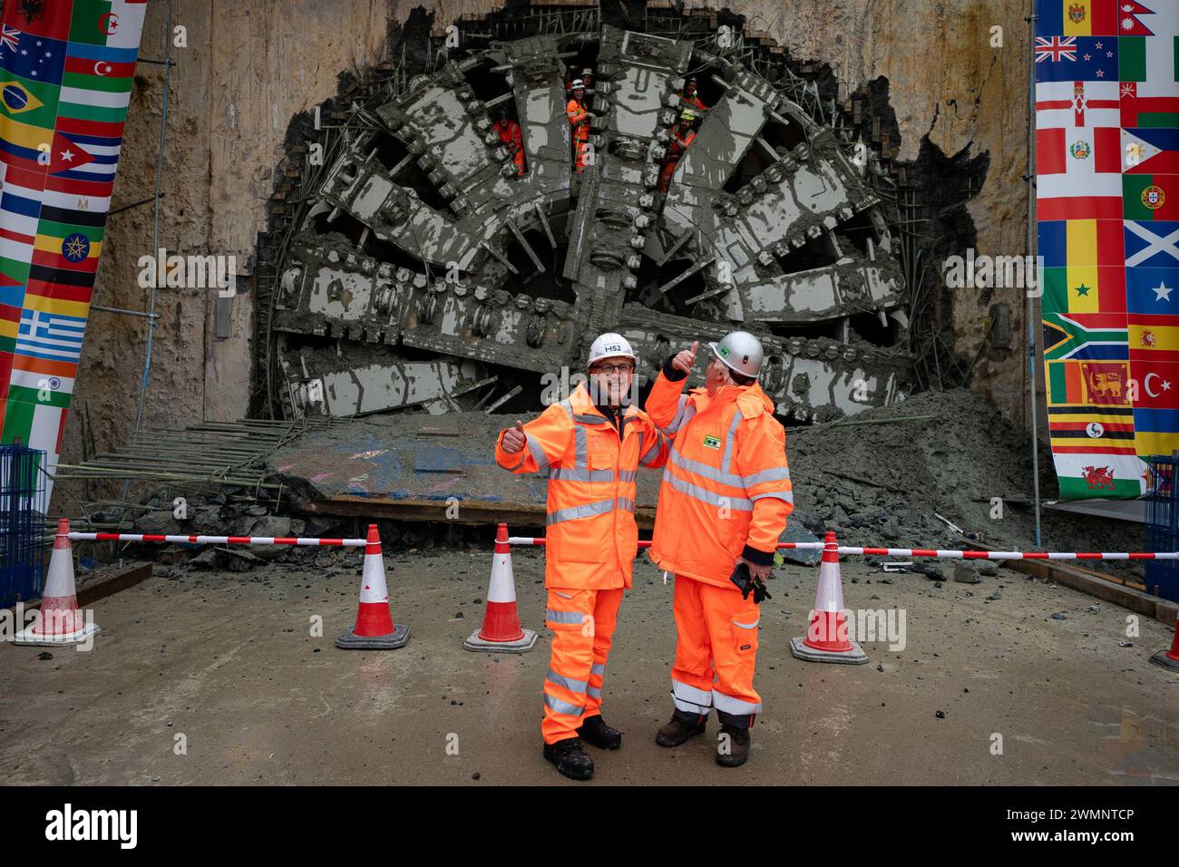 Workers pose for a photograph as members of the tunnel boring team look ...
