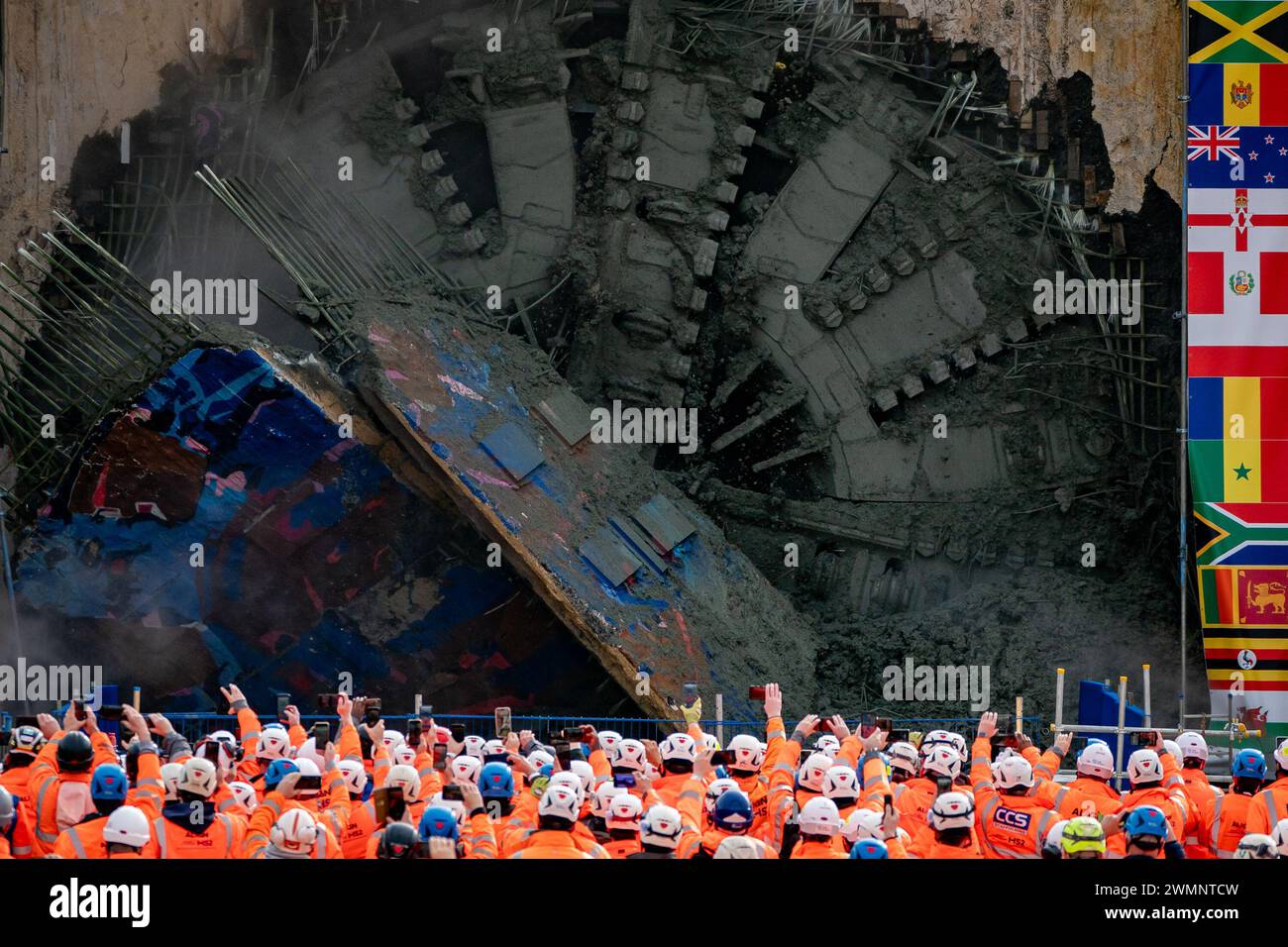 Workers hold up their mobile phones as digging machine Florence ...