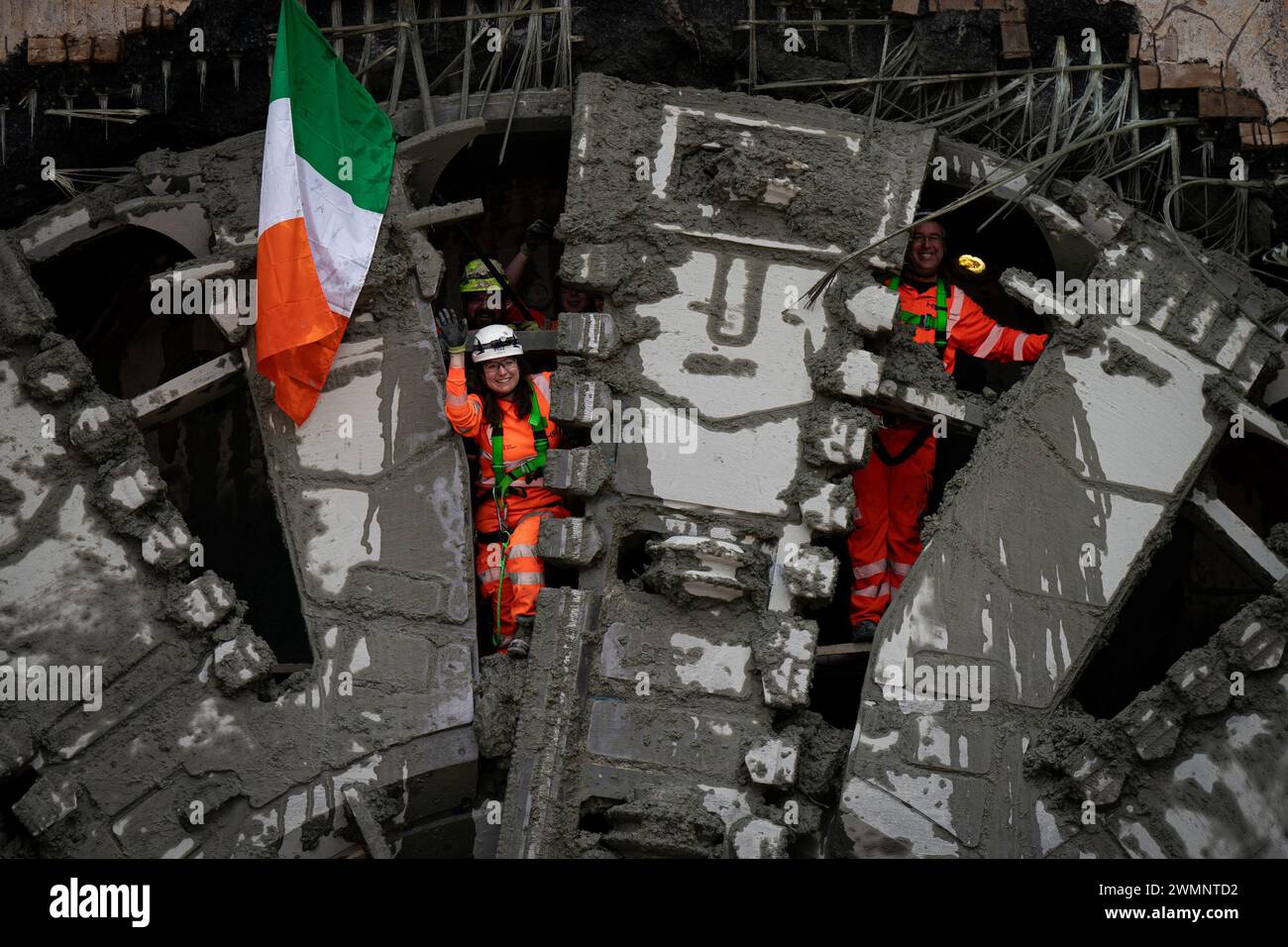 Members of the tunnel boring team look out from digging machine ...