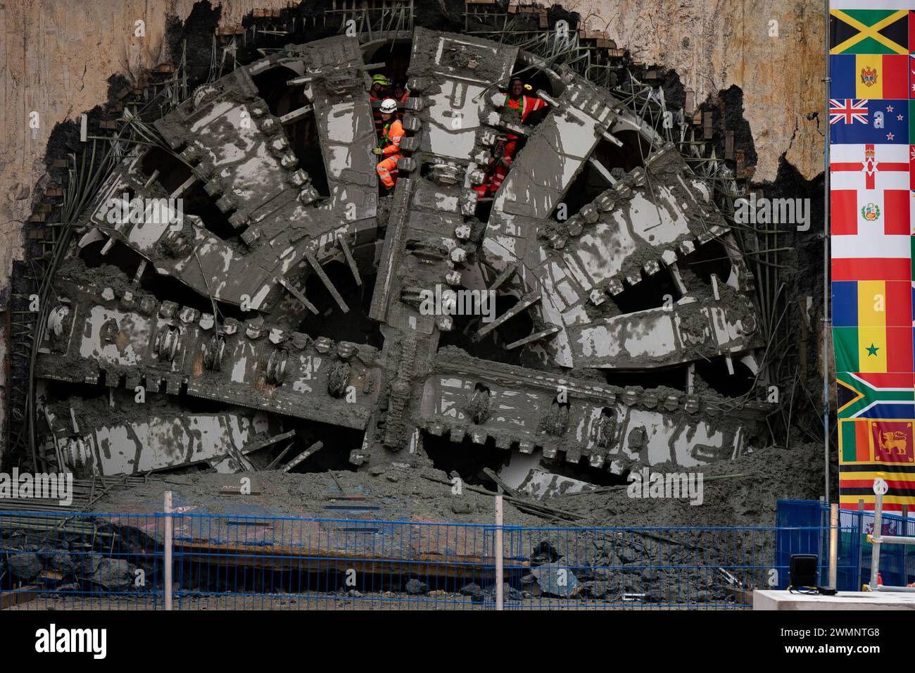 Members of the tunnel boring team look out from digging machine ...