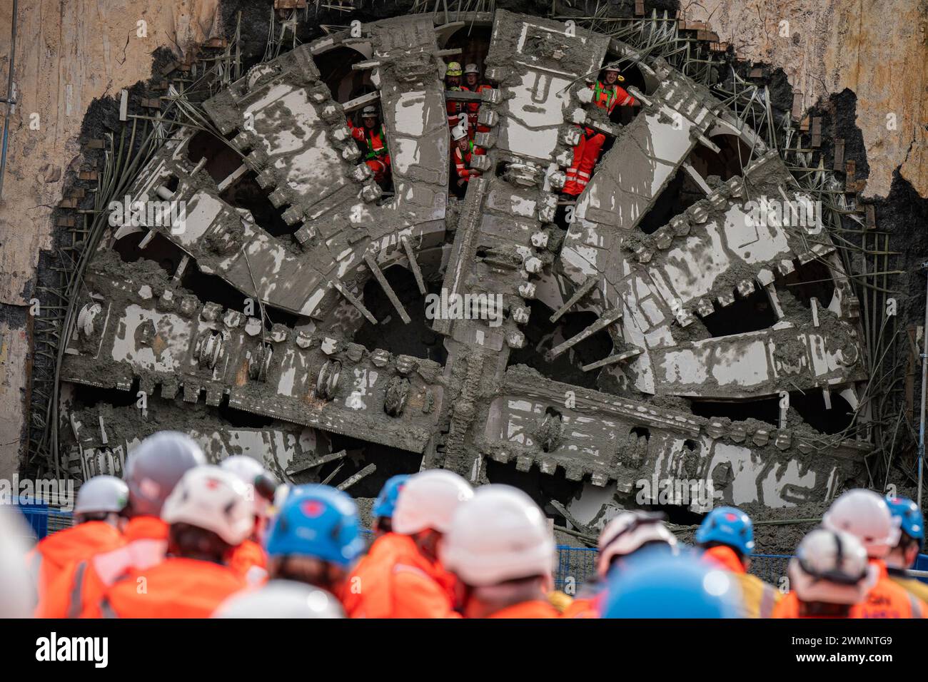 Members of the tunnel boring team look out from digging machine ...