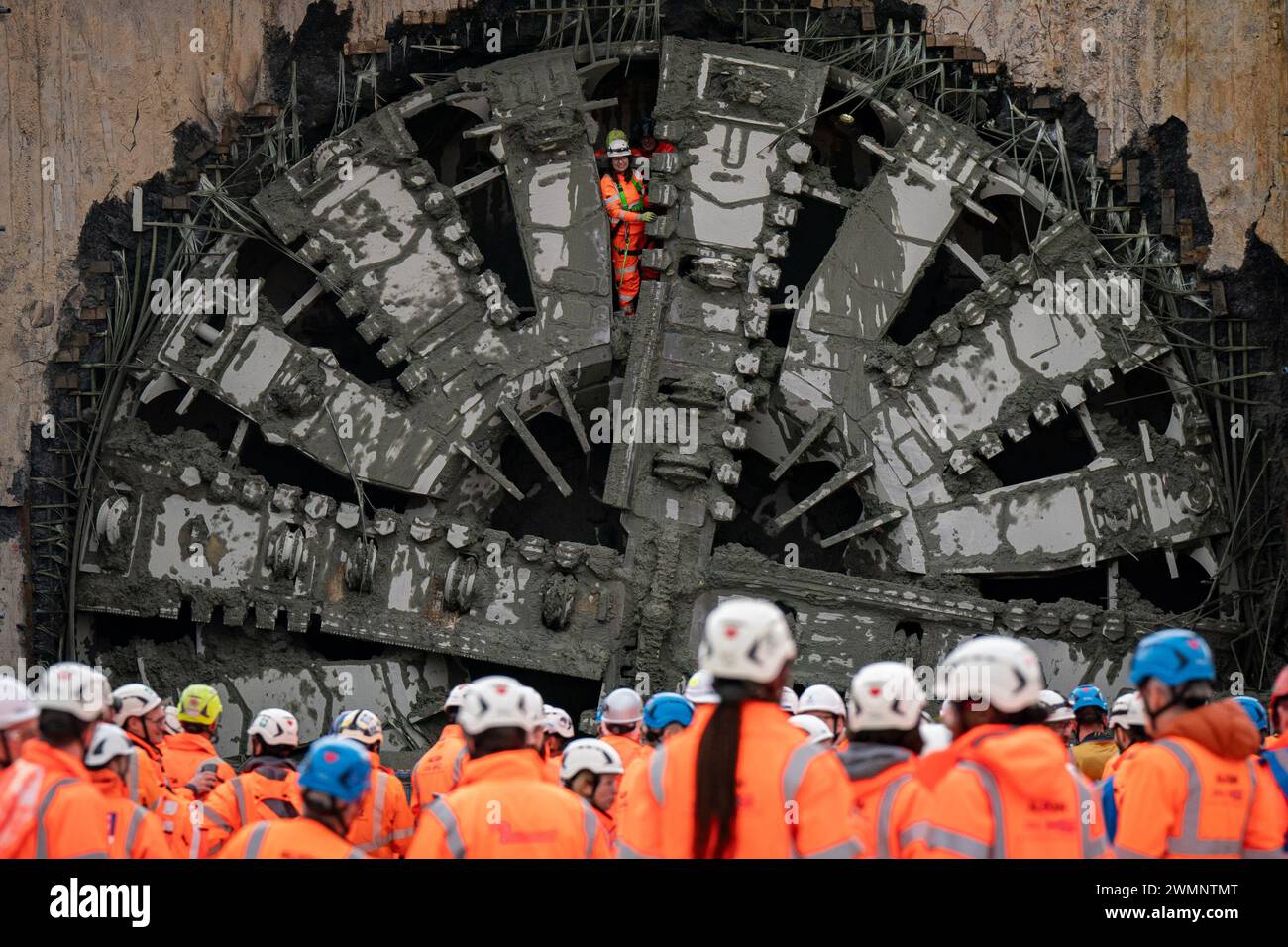 A member of the tunnel boring team looks out from digging machine ...