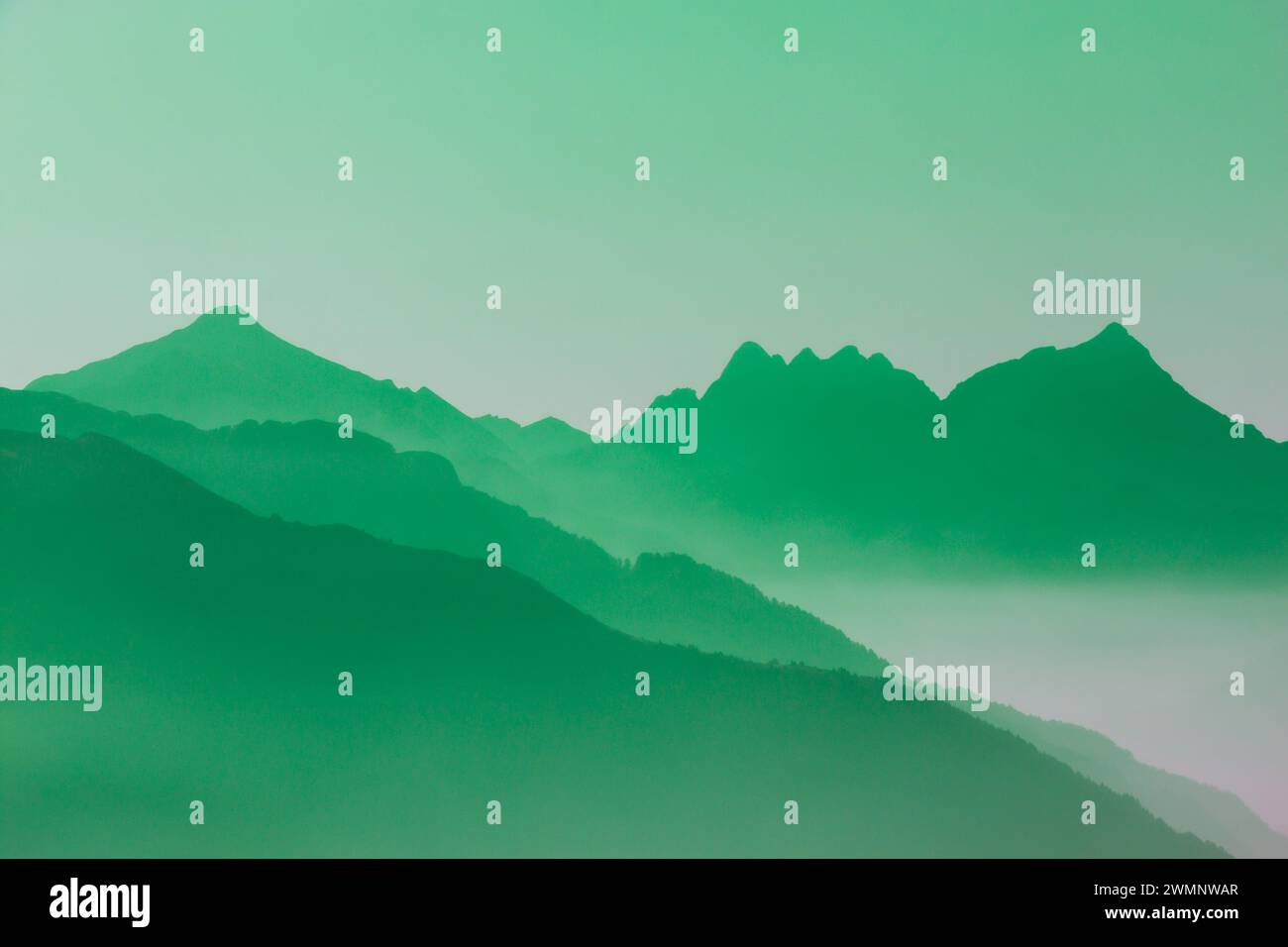 Spectacular mountain ranges silhouettes in shades of green Stock Photo ...