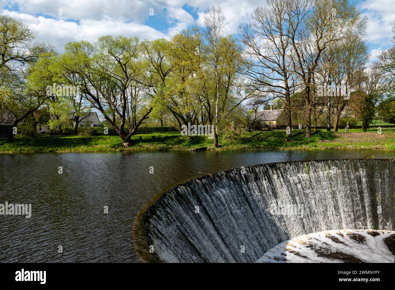 Water flows from a small semi-circular dam in a small village by the ...