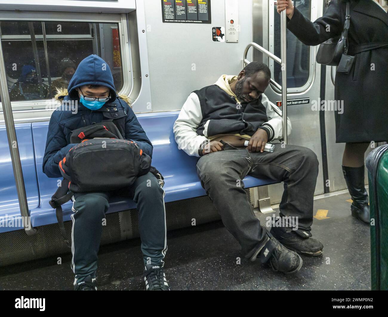 Homeless man sleeps on the seats in a New York subway car on Saturday ...