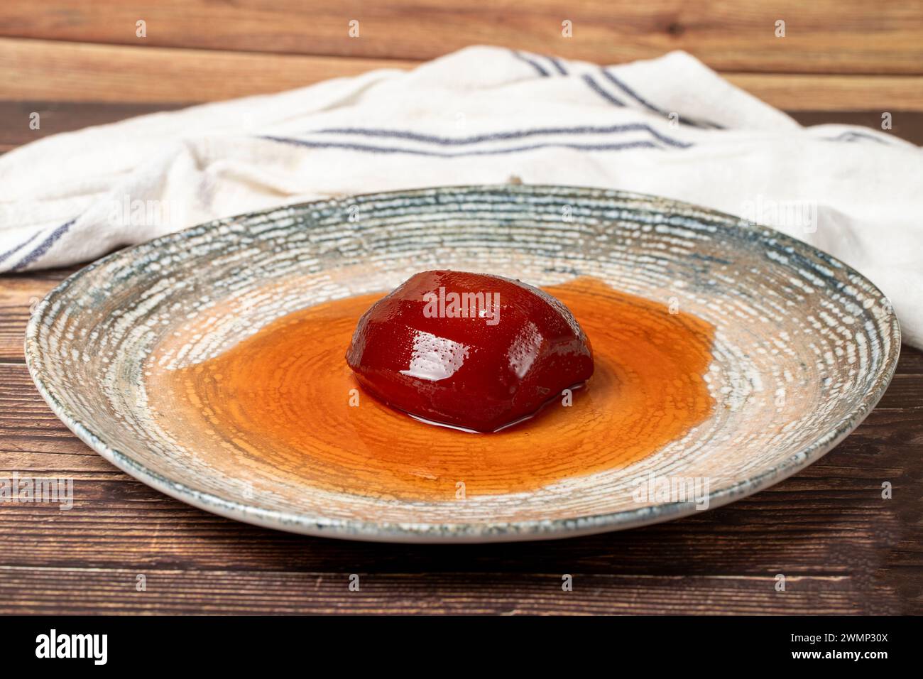 Quince dessert with syrup. Milk dessert. Quince dessert on a plate ...
