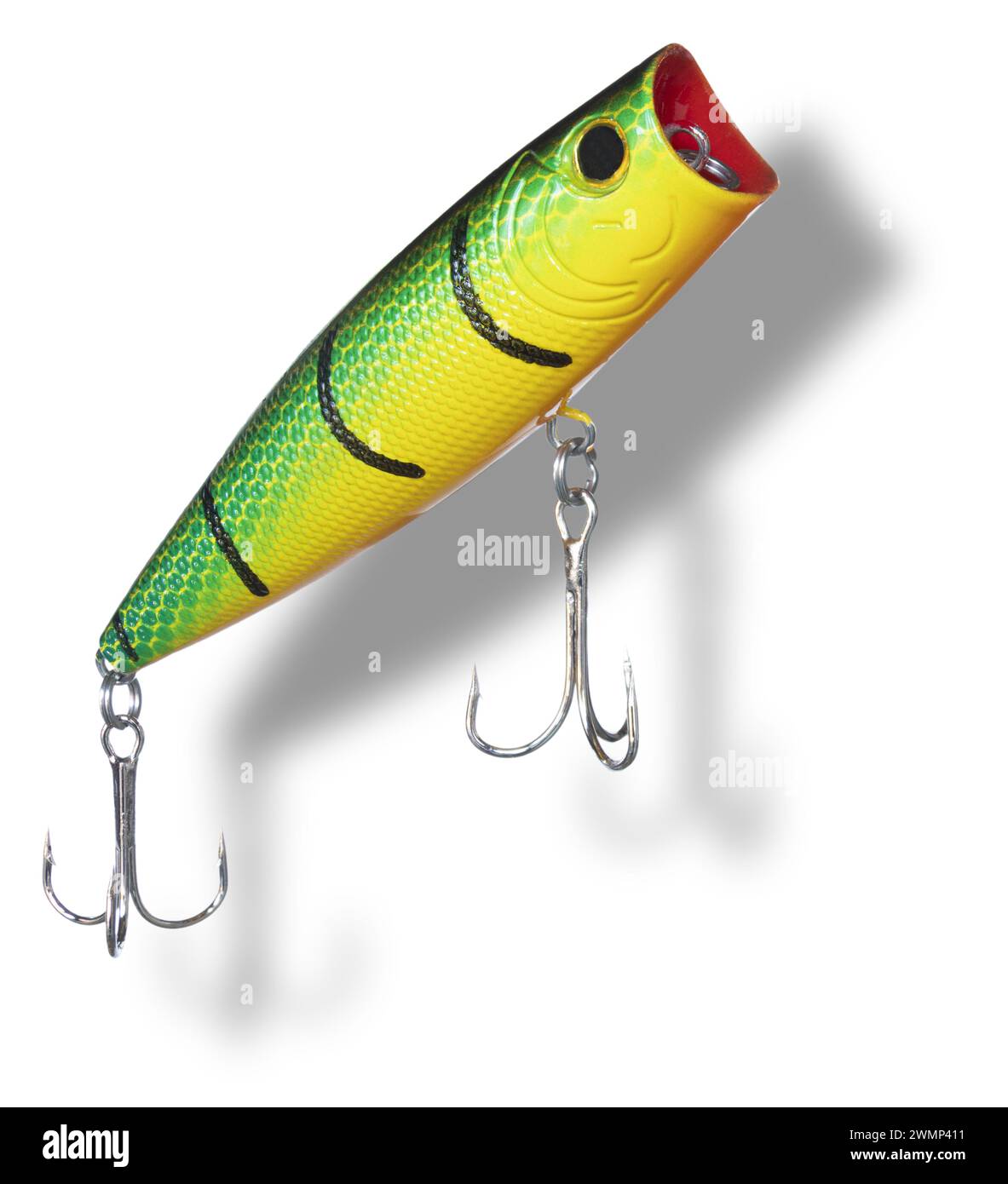 Shadow below a topwater artificial fishing bait with green, yellow and ...