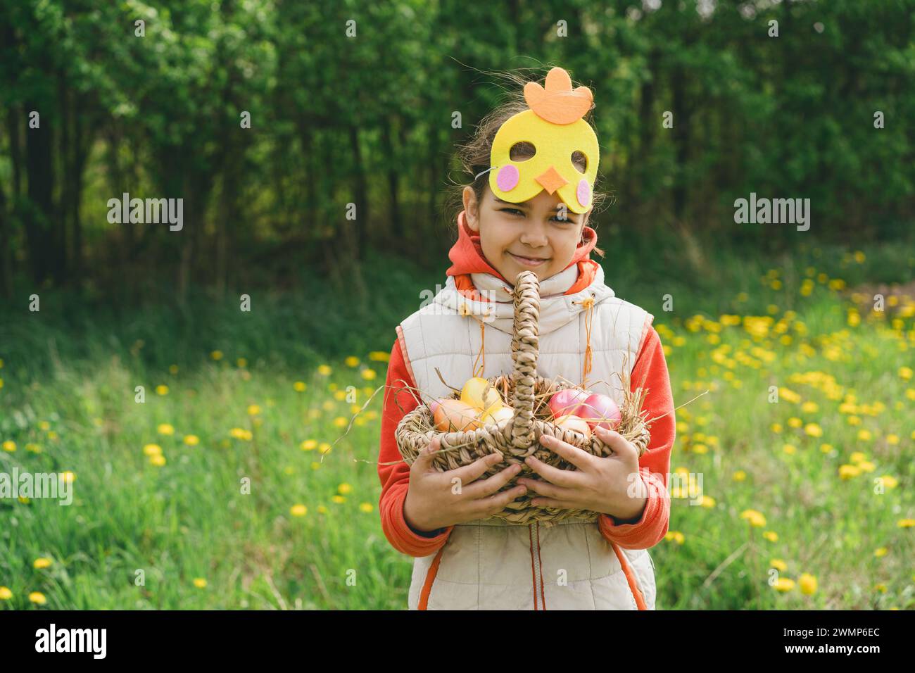 Girl with eggs basket and with a chicken mask on Easter egg hunt Stock ...