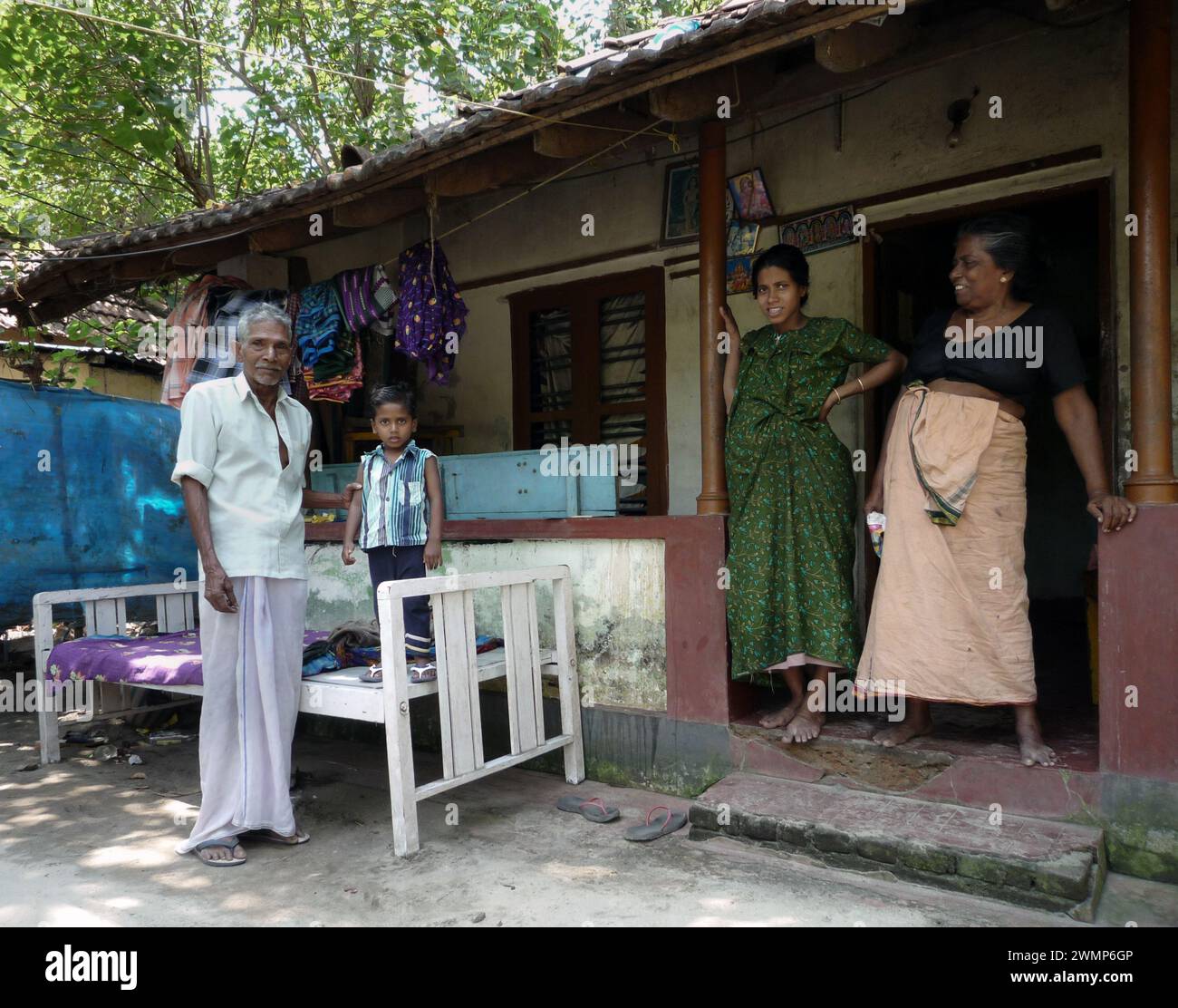 India, Kerala, Cochin: an Indian family on the doorstep of their home ...