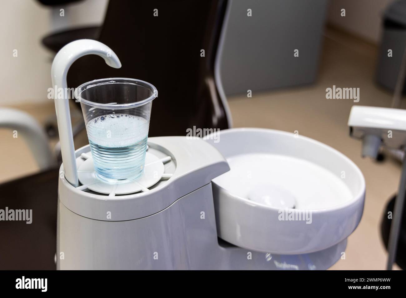 Disposable glass filled with CHX mouth rinse next to spiotoon bowl in ...