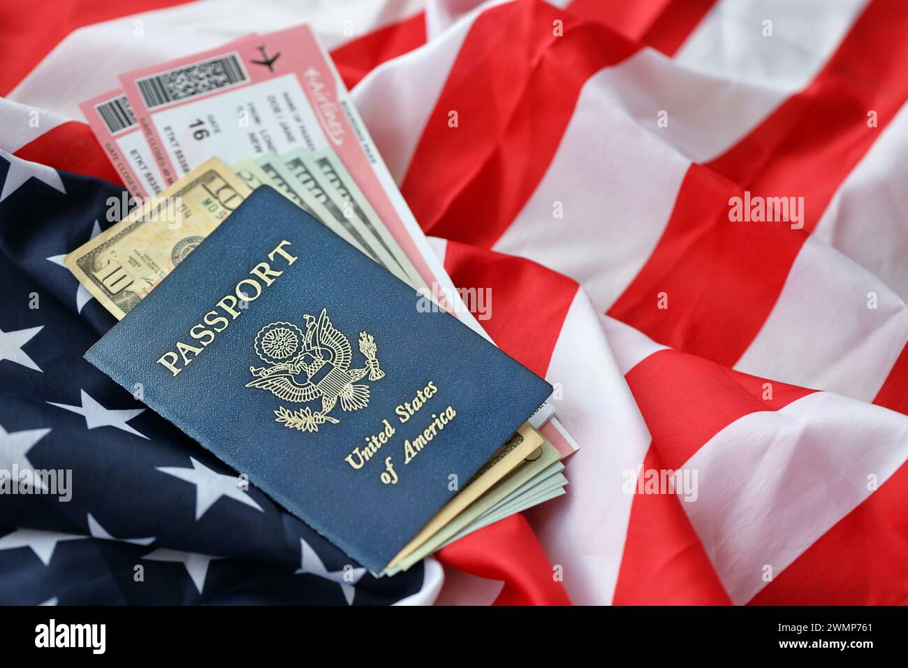 Blue United States of America passport with money and airline tickets ...