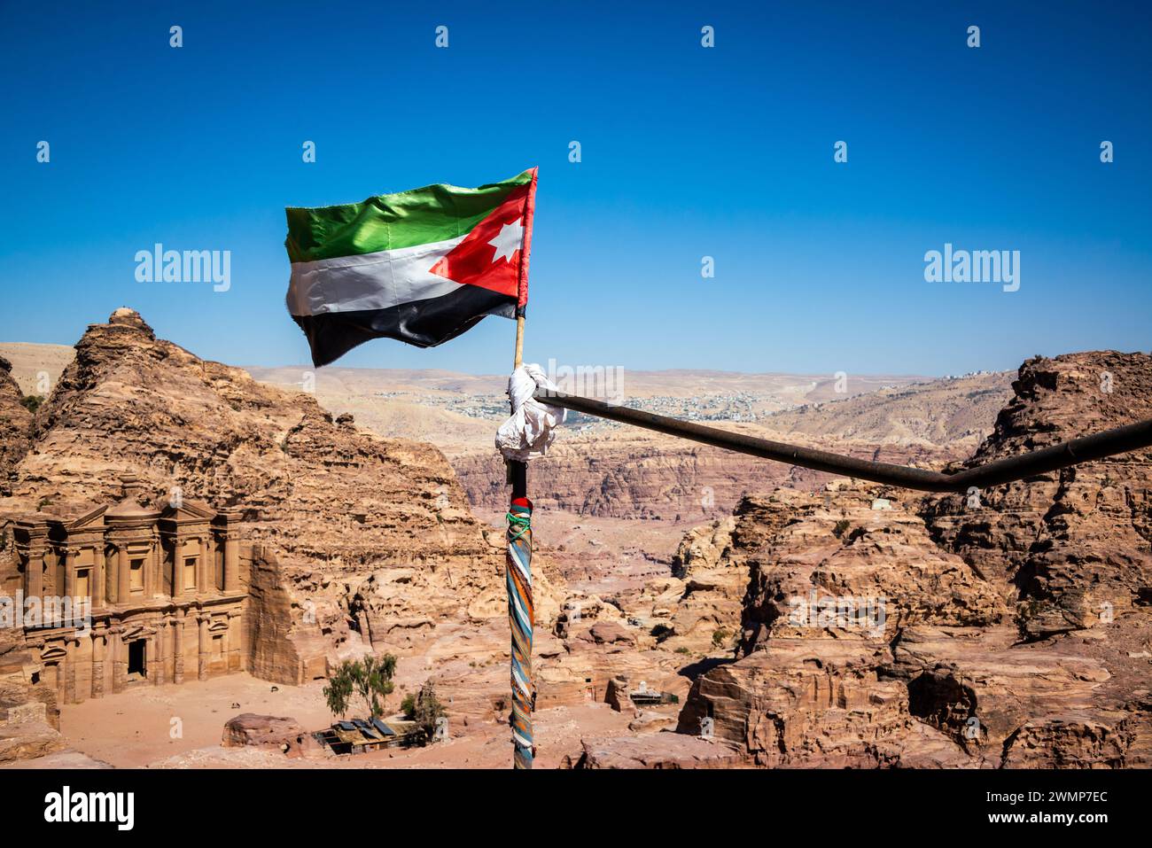 Jordanian flag blowing in the wind with the building known as the ...
