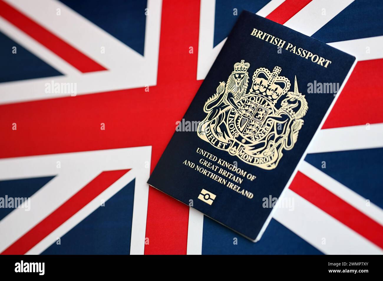 Blue British passport on national flag background close up. Tourism and ...