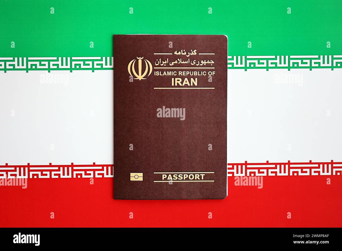 Red Islamic Republic of Iran passport on national flag background close ...