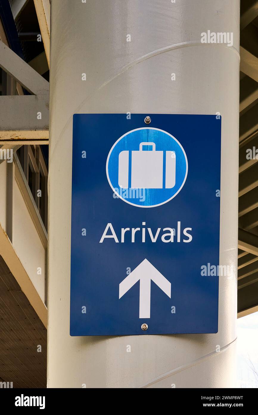 A blue and white sign with a suitcase in a circle indicaating the ...