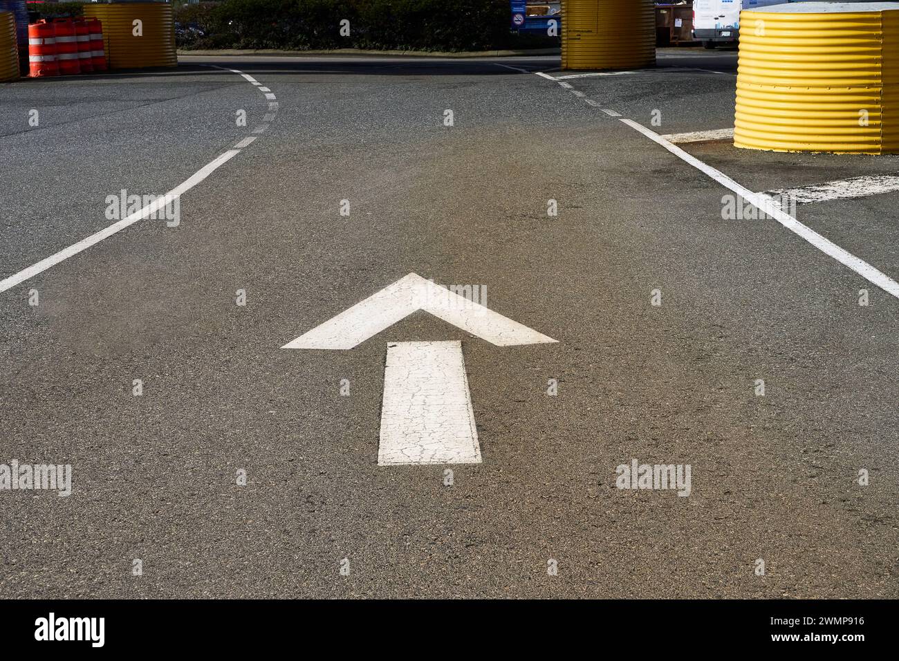 White arrow painted between two lines on the pavement at a ferry ...