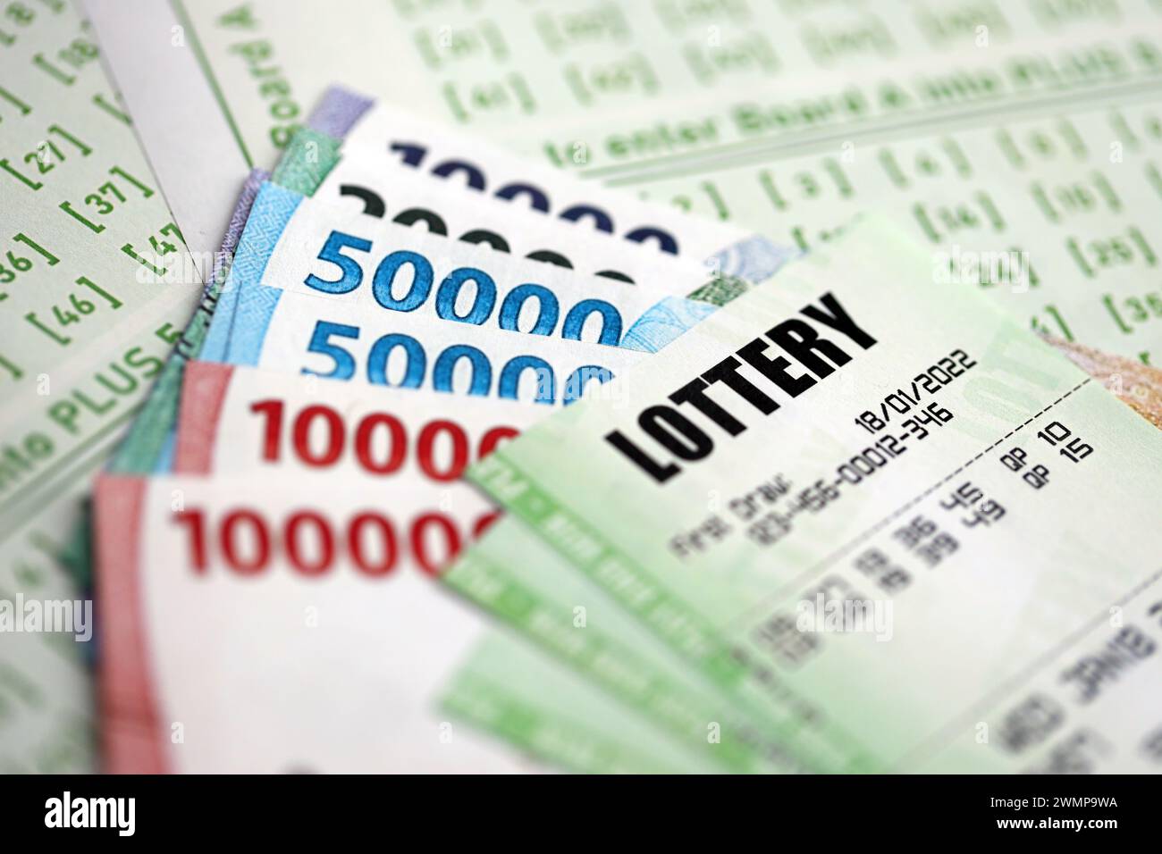 Green lottery tickets and indonesian money bills on blank with numbers ...