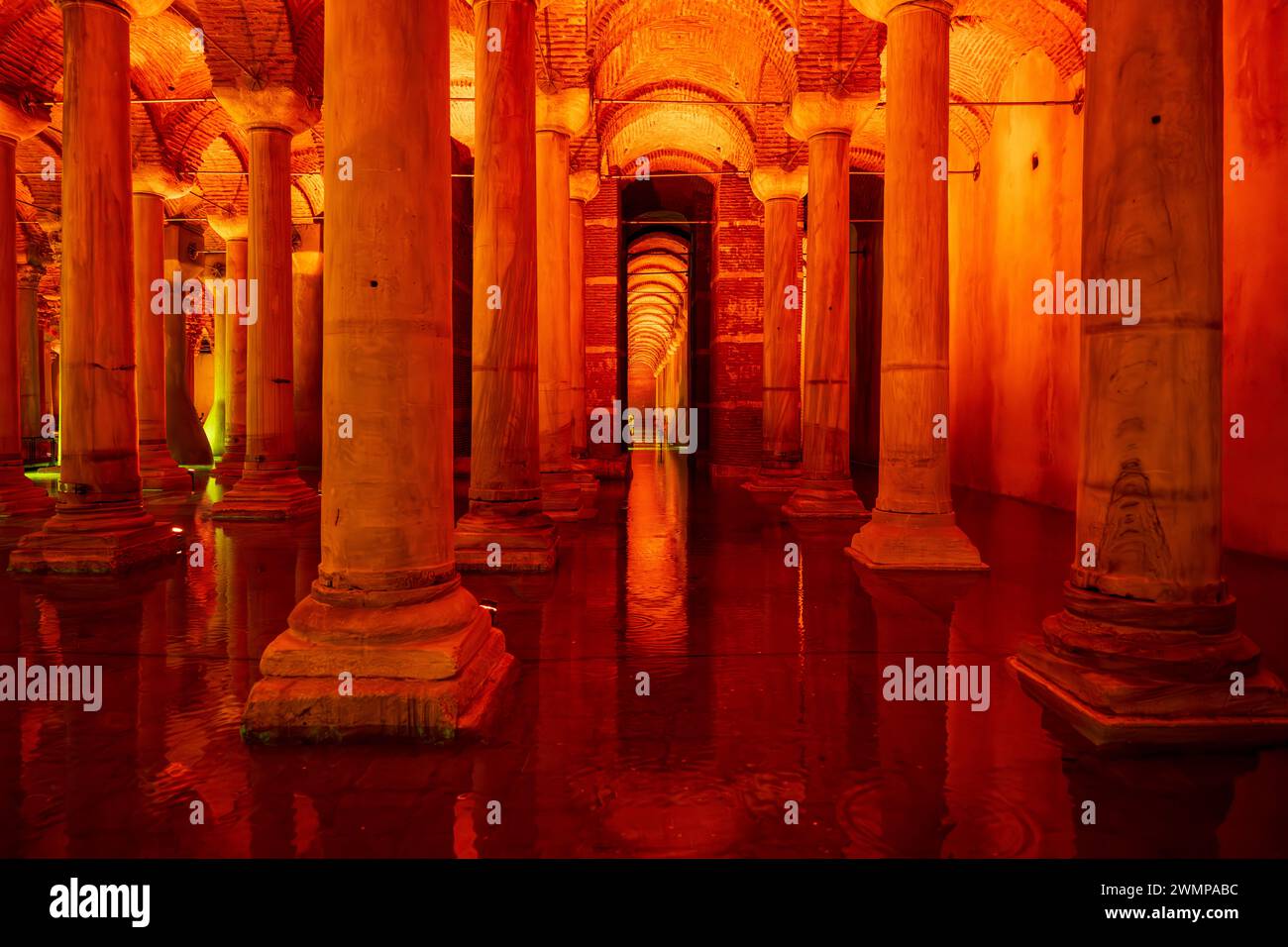 An illuminated path leads to a structure with arches and columns in ...