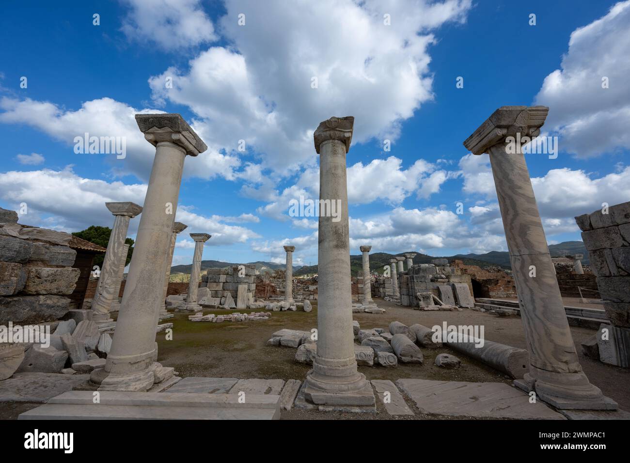 The ruins of ancient Ephesus with grand columns under clear blue sky ...