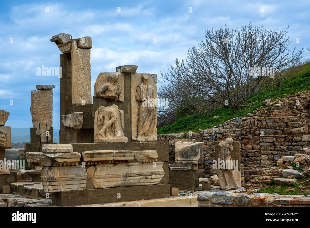 A stone structure stands amidst rocks and trees in Ephesus, Turkey ...