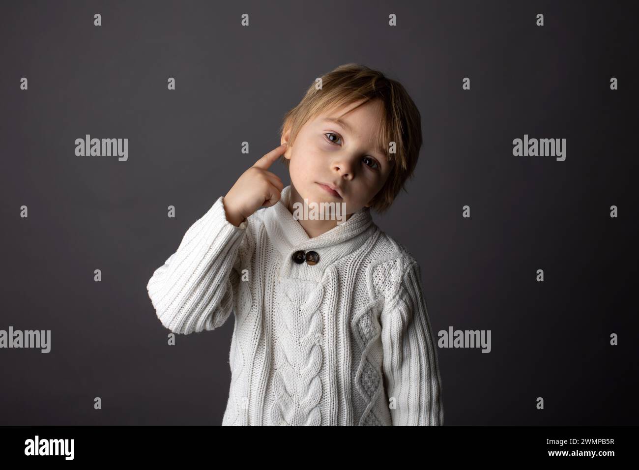 Cute little toddler boy, showing DEAF gesture in sign language on gray ...