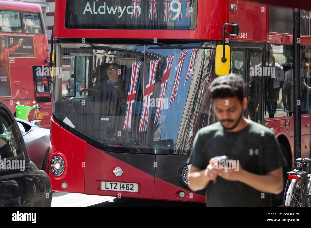 Union flags are reflected in a double-decker bus as London prepares for ...