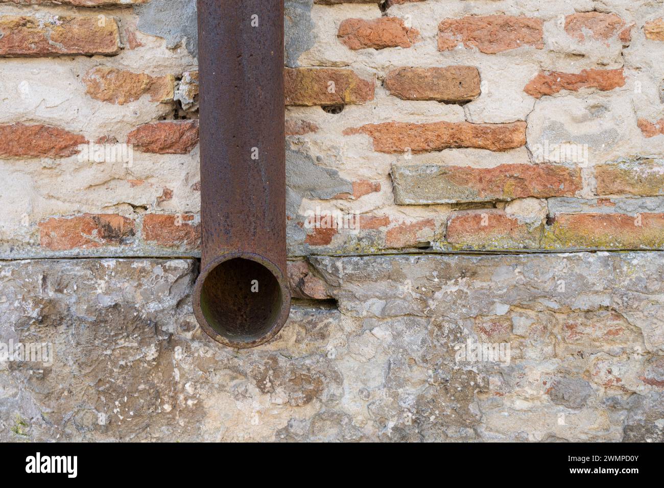 the old pipe of a gutter on a brick wall Stock Photo - Alamy