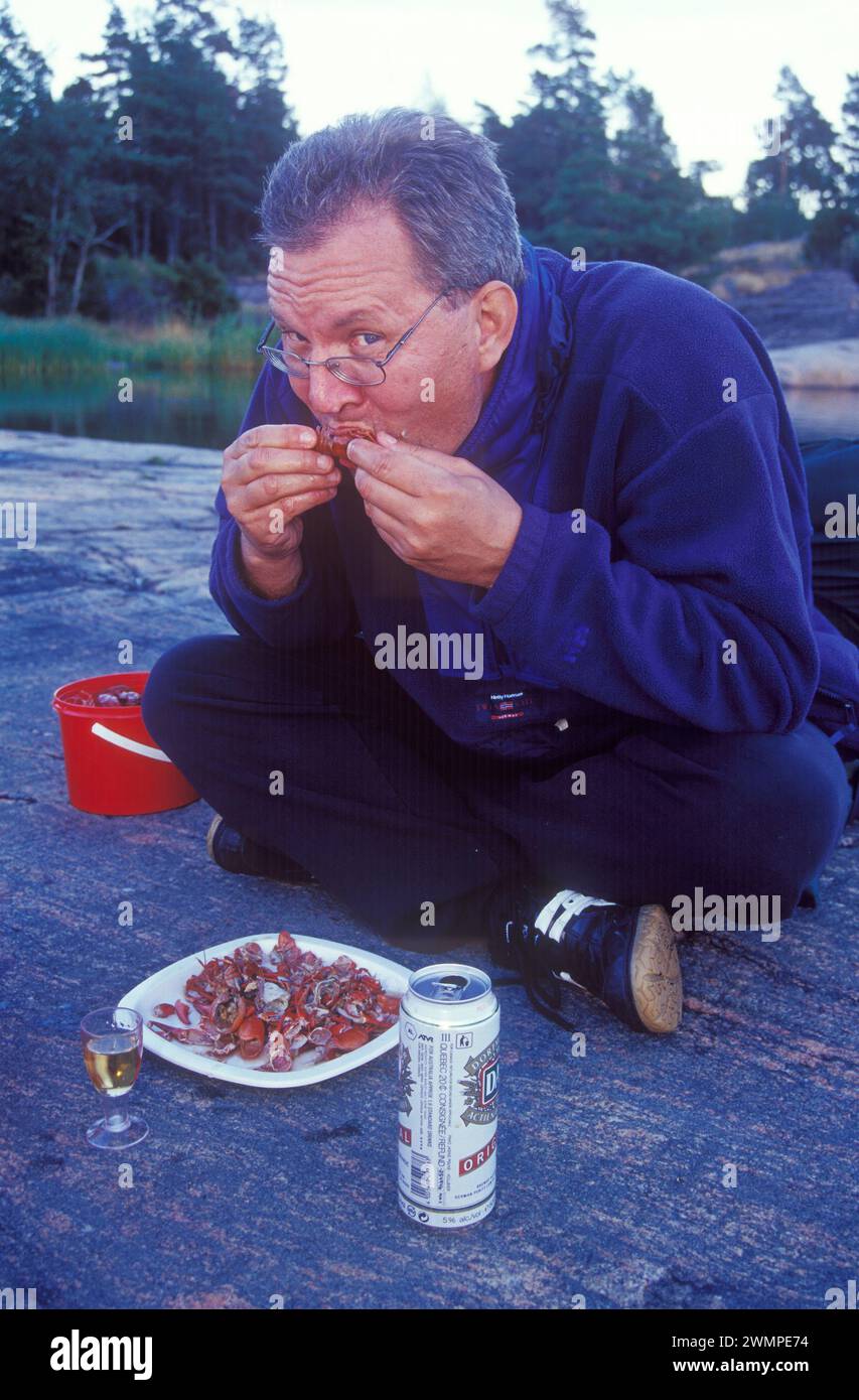 Man eating crayfish outdoors Stock Photo - Alamy