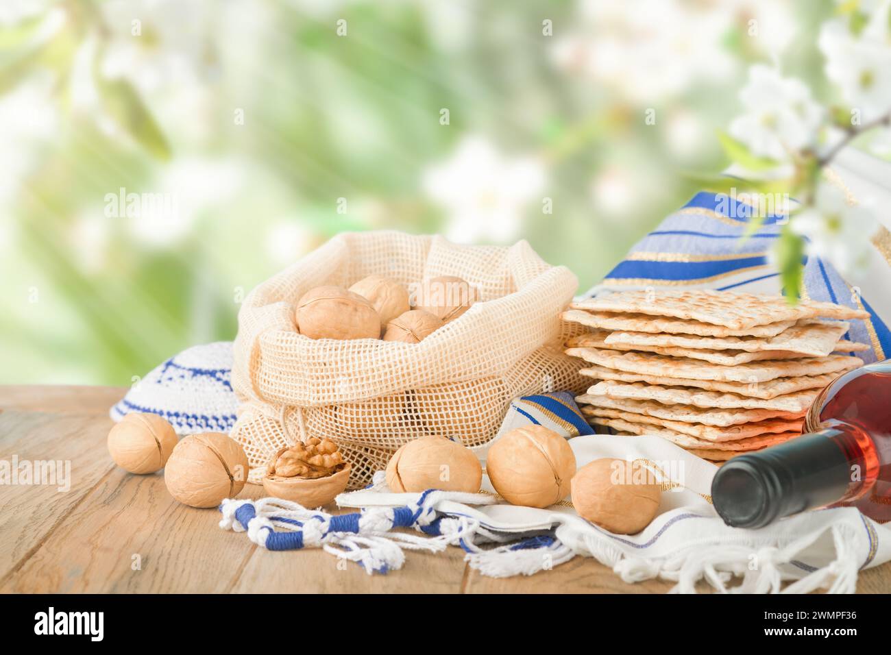 Passover celebration concept. Matzah, red kosher and walnut on wooden ...