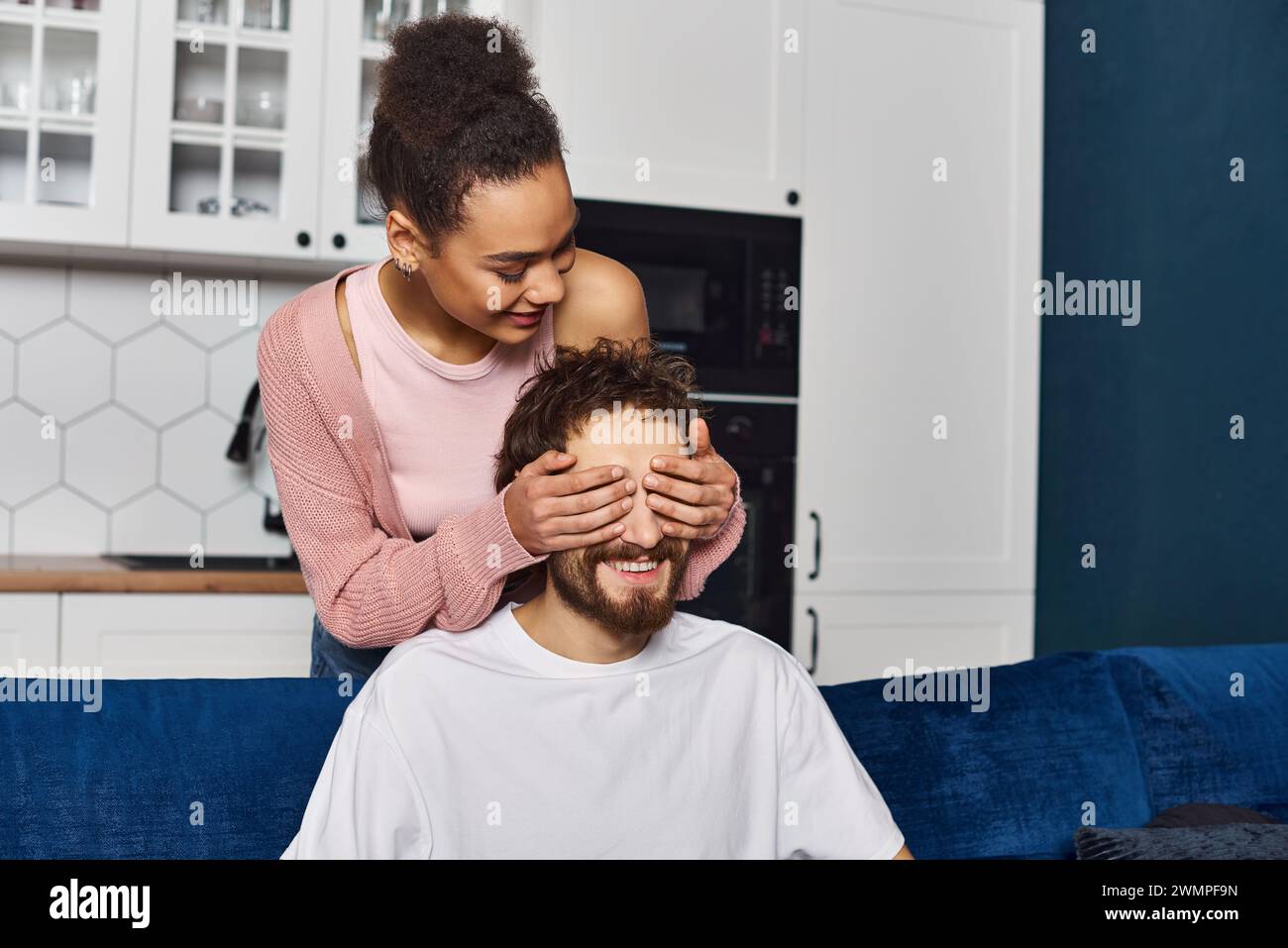 appealing joyous african american woman closing her boyfriend eyes with ...