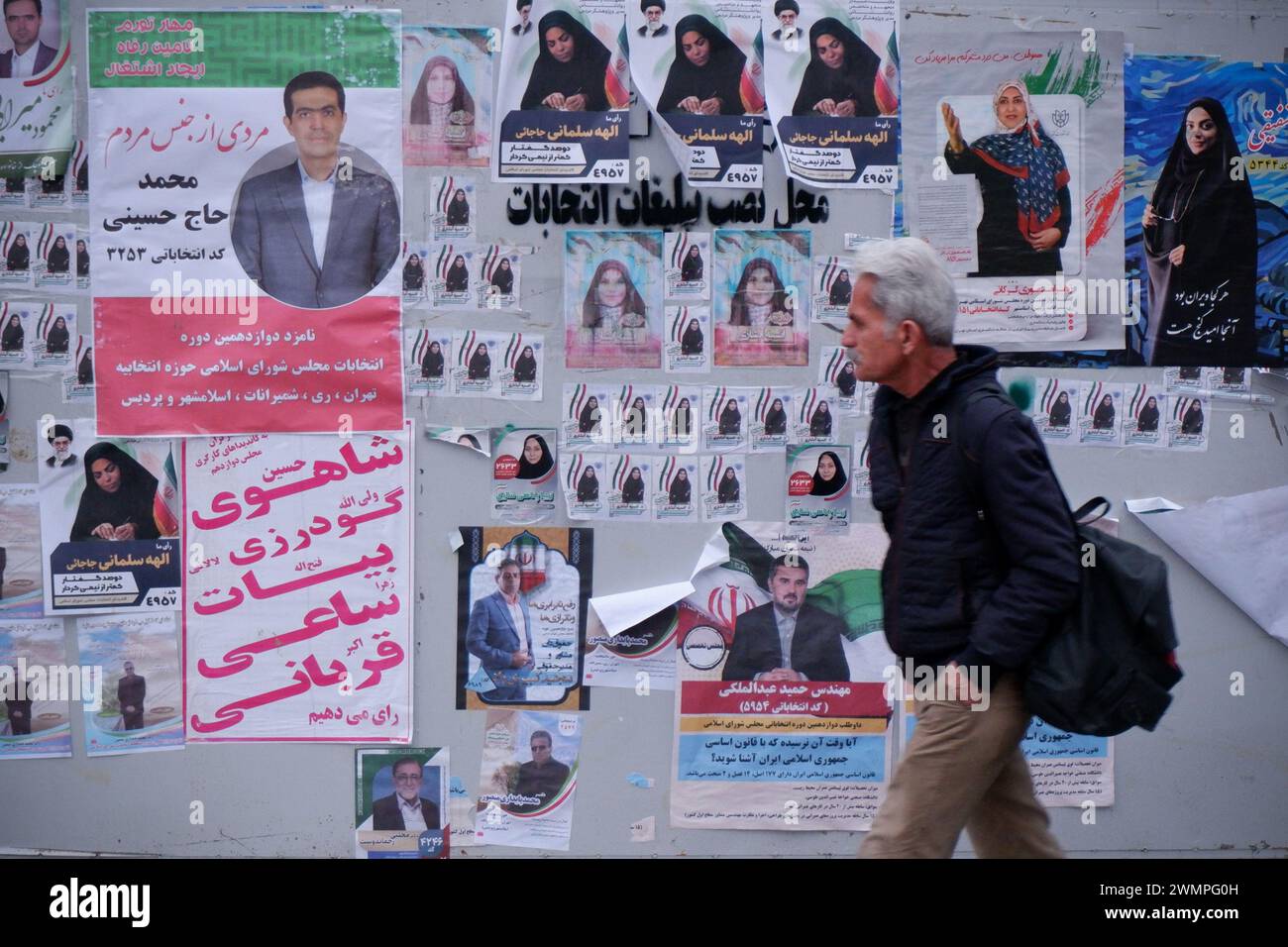 Tehran, Iran. 27th Feb, 2024. An Iranian man walks next to the ...