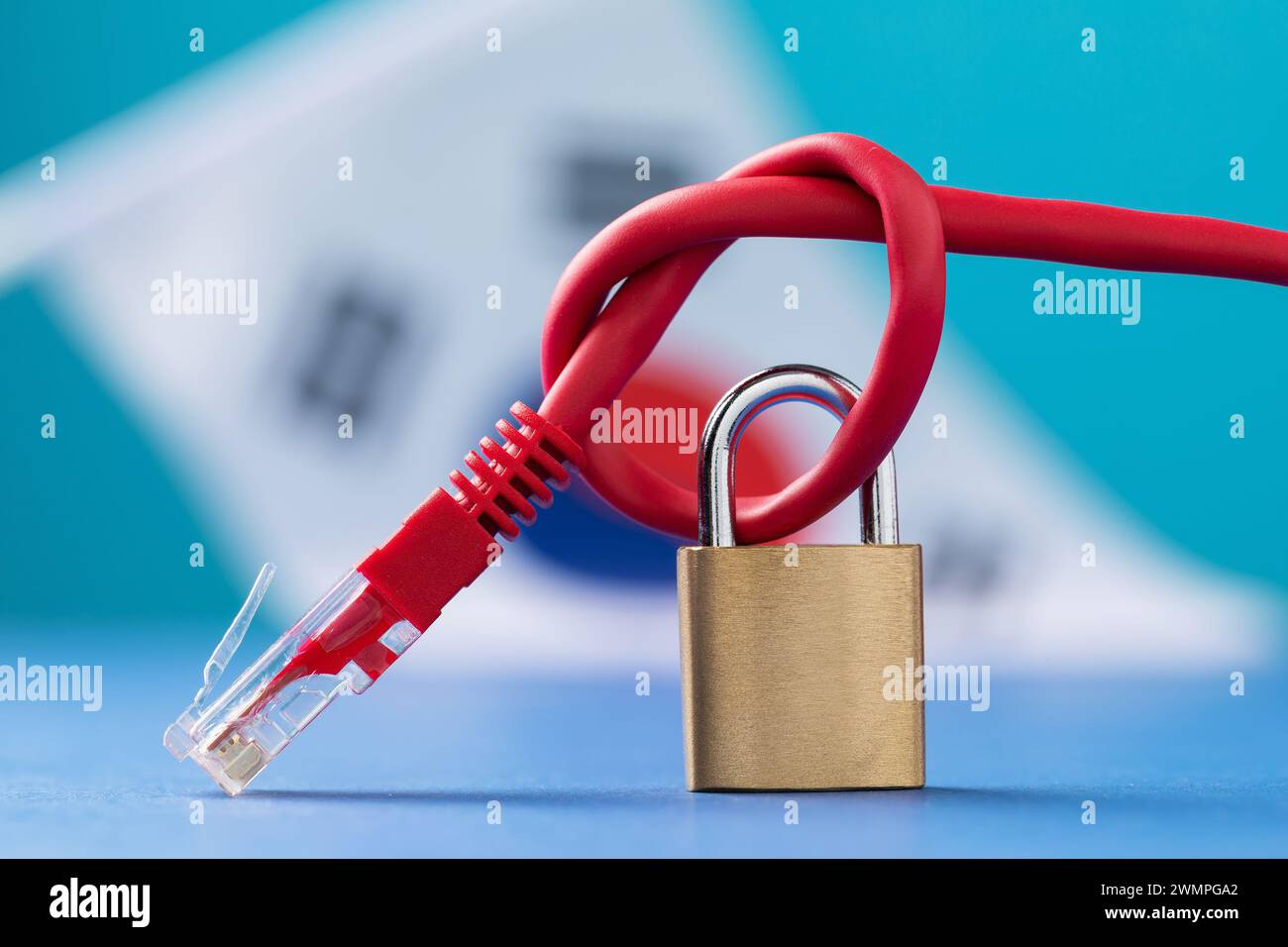 A closed lock on a tied network wire into a knot against the background ...