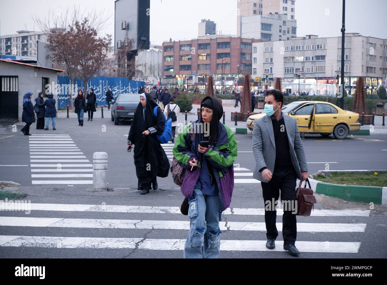 Tehran, Iran. 27th Feb, 2024. Iranian people cross a street in downtown ...