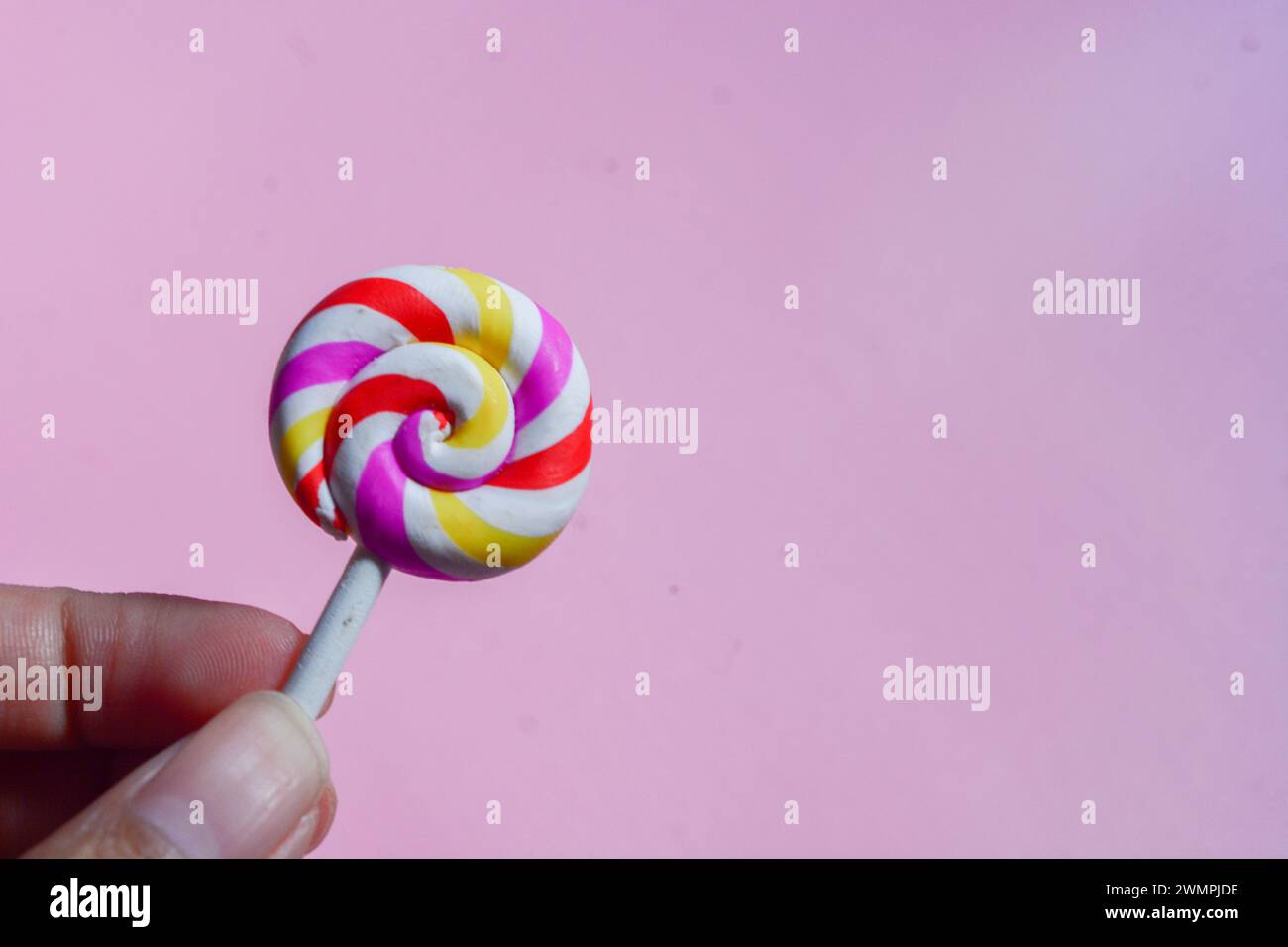 Little candies on a pink background Stock Photo - Alamy