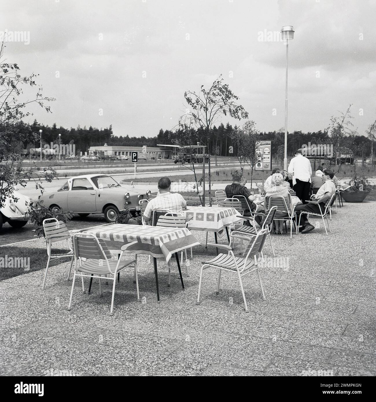 1960s, historical, motorists at a waiter service rest-stop beside an ...