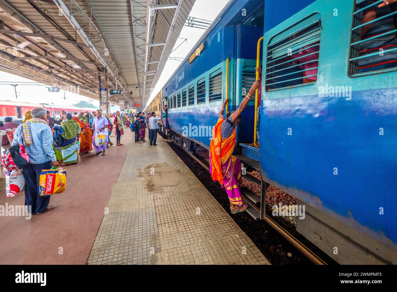 Passengers boarding / disembarking from a train of the Indian railways ...