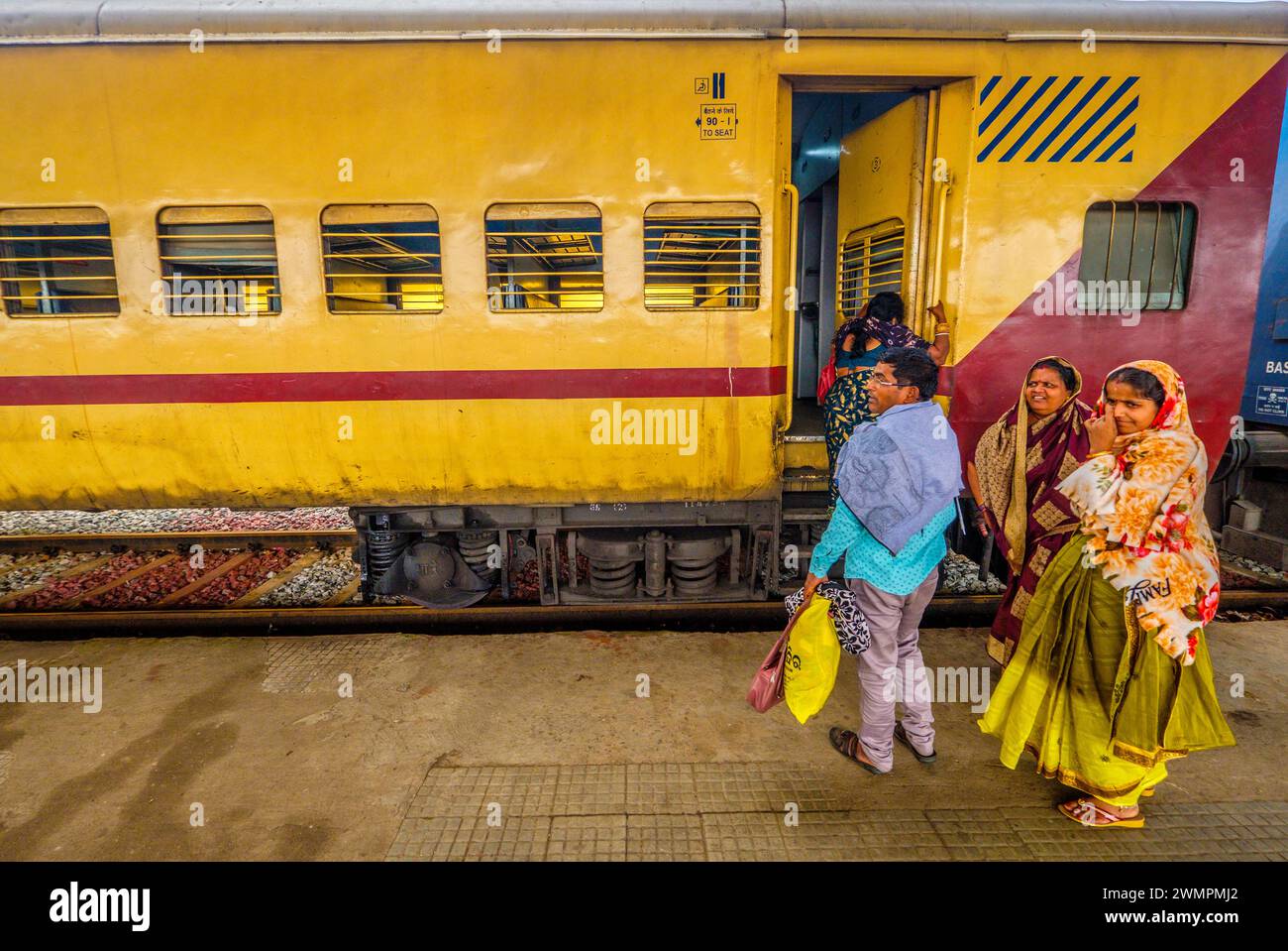 Passengers boarding / disembarking from a train of the Indian railways ...